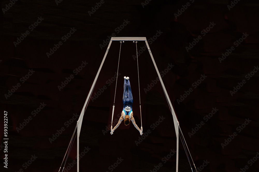 male gymnast performing on ring frame competition artistic gymnastics ...