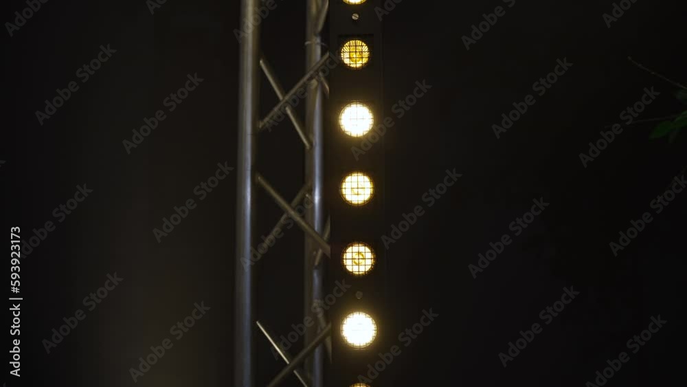 Stage lighting fixture is attached to vertical metal truss, white ...