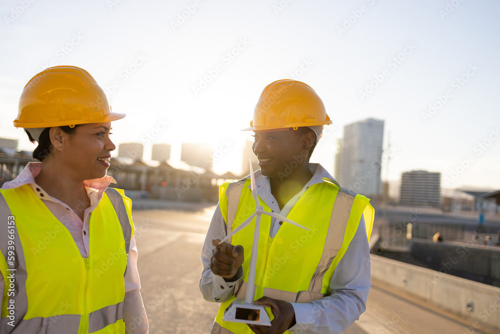 Black engineers with wind turbine on construction site Stock Photo ...
