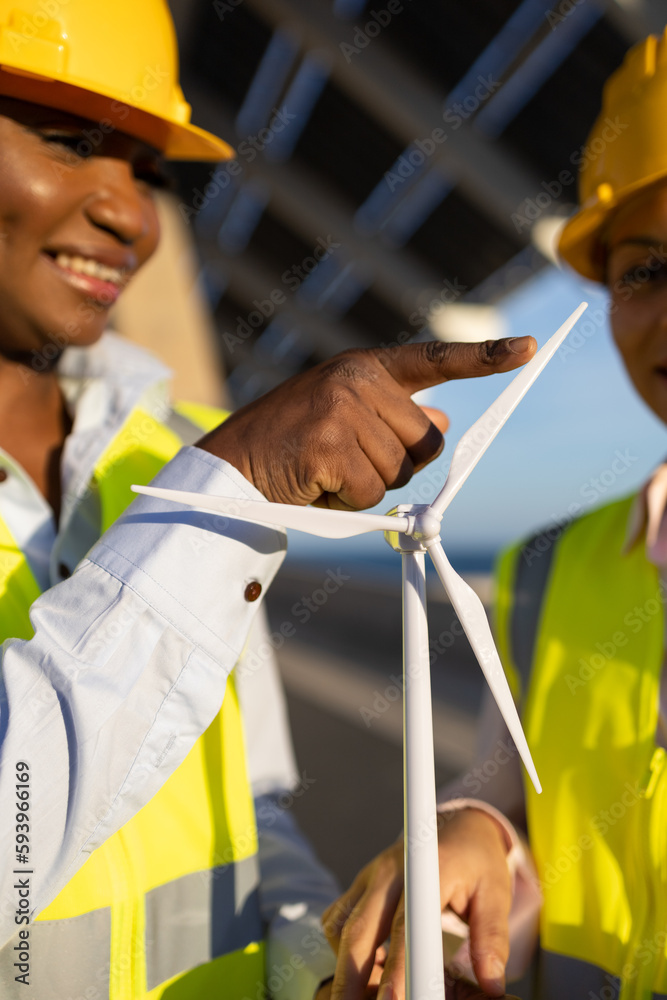 Smiling engineers using wind turbine on construction site Stock Photo ...