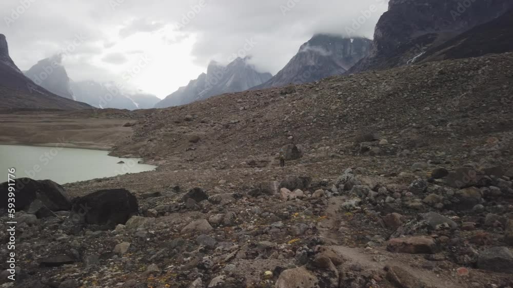 Male hiker with very big and heavy backpack walking around summit lake ...