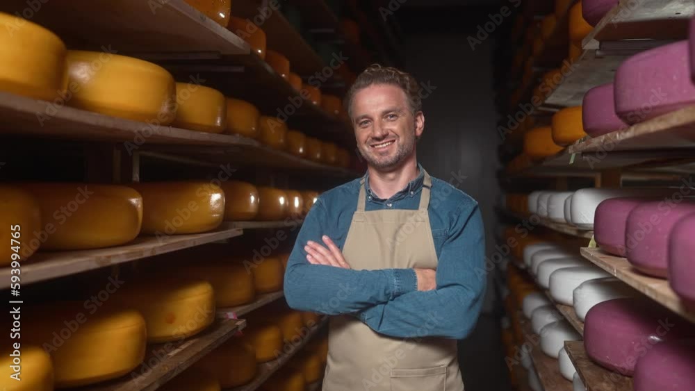 Zooming in Caucasian man with apron standing in shadow storage ...