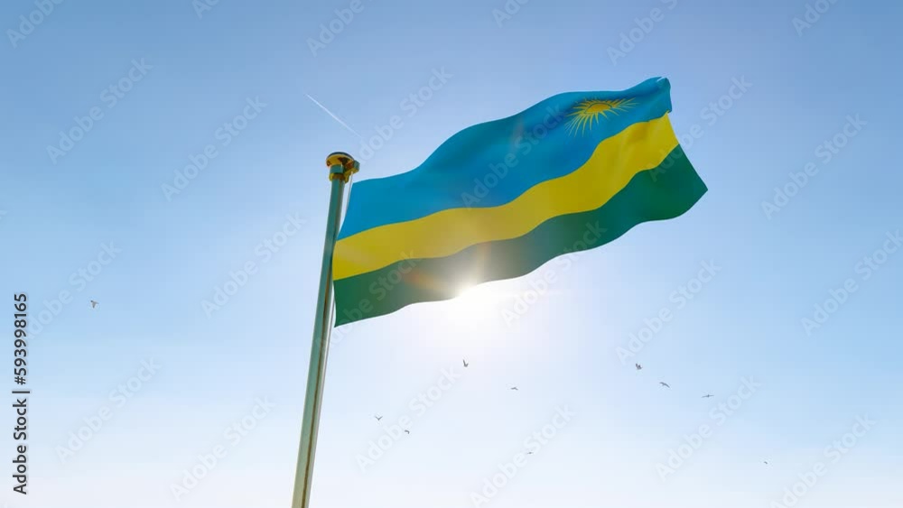 Rwanda national flag waving in beautiful blue sky. Flag of Rwanda ...