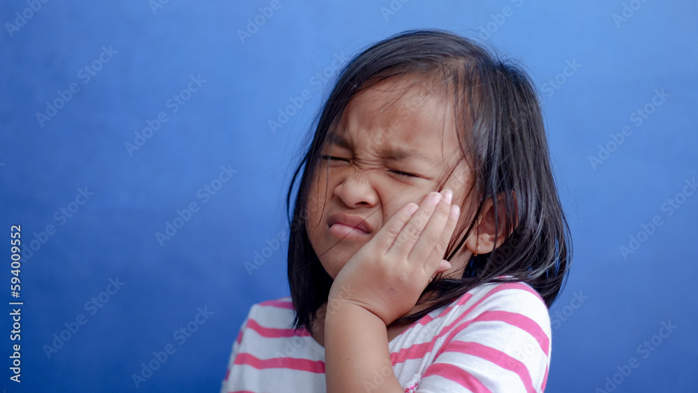 Asian kid girl toothache. Kid suffering from toothache. Asian child ...