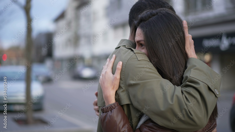 Couple embrace standing in street in empathic hug. Caring and ...