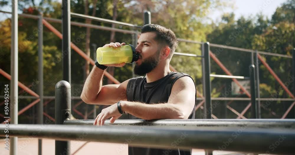 Athletic man drinking water after grueling cardio. End of workout, good ...
