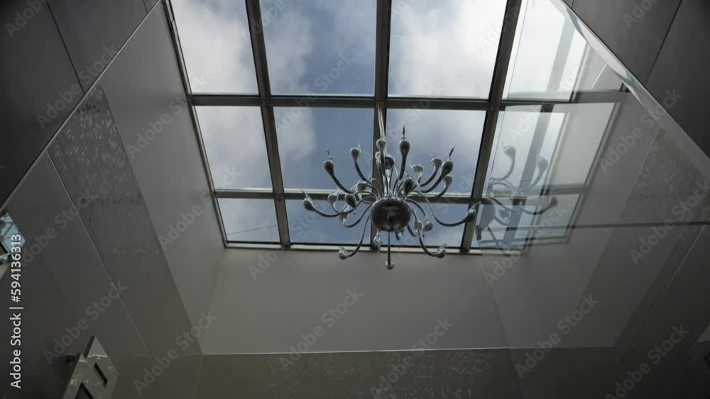 glass ceiling serving as a light well to a magnificent modern bathroom ...
