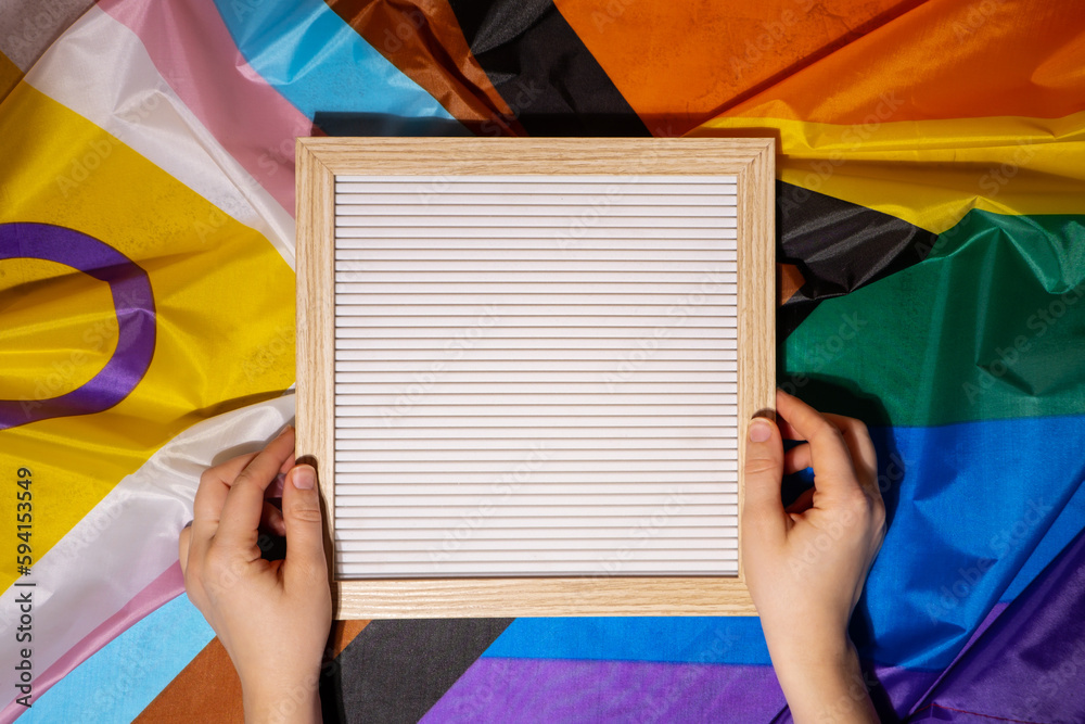 Empty blank frame on Rainbow LGBTQIA flag made from silk material with ...