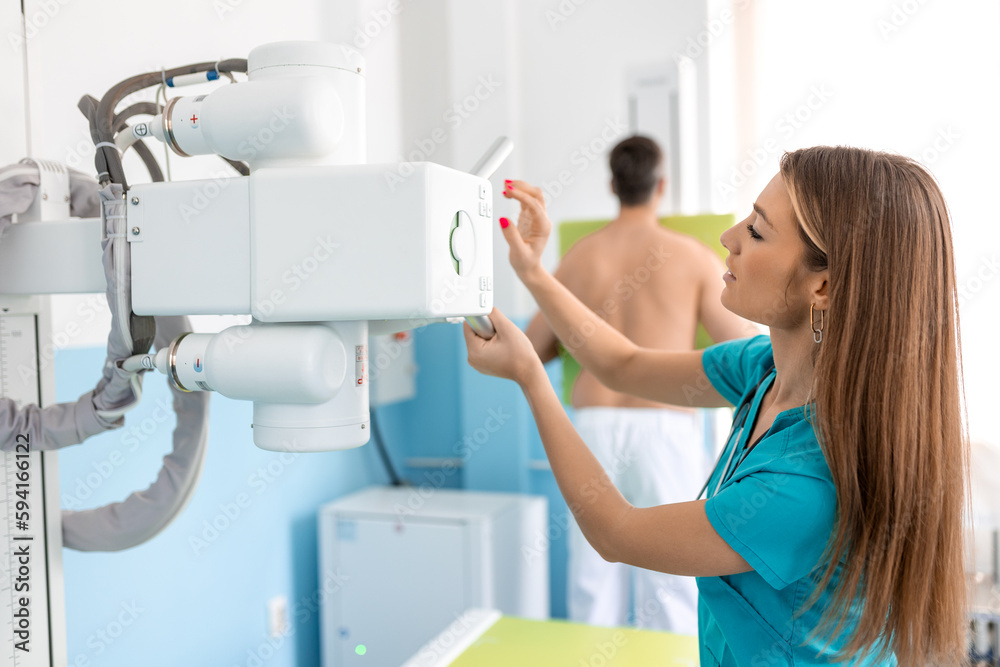 In the Hospital, Man Standing Face Against the Wall While X-Ray Machine ...