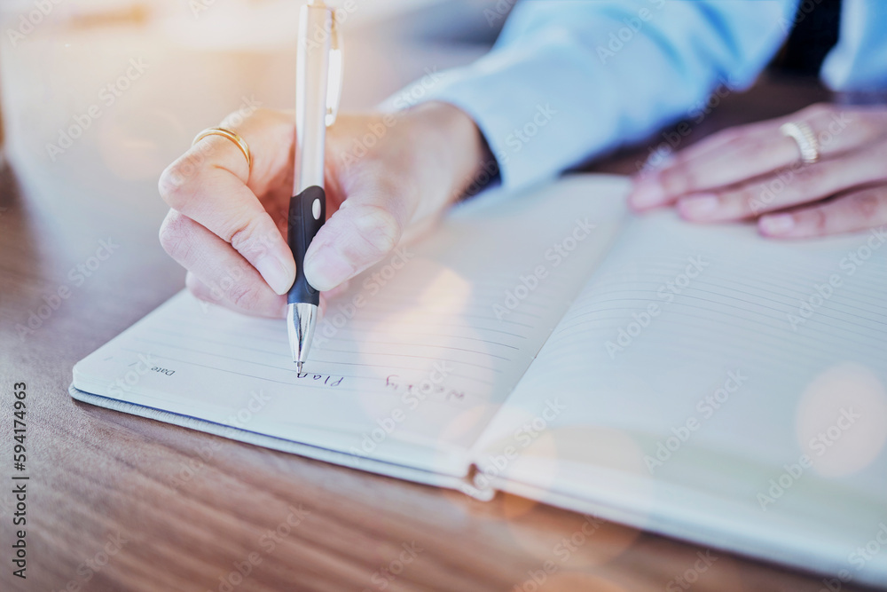 Notebook, pen and hands writing ideas, planning schedule and research ...