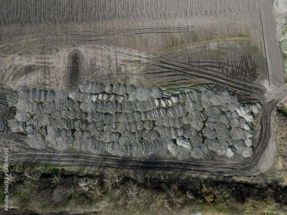 piles of manure are delivered from the landfill to the field where the ...