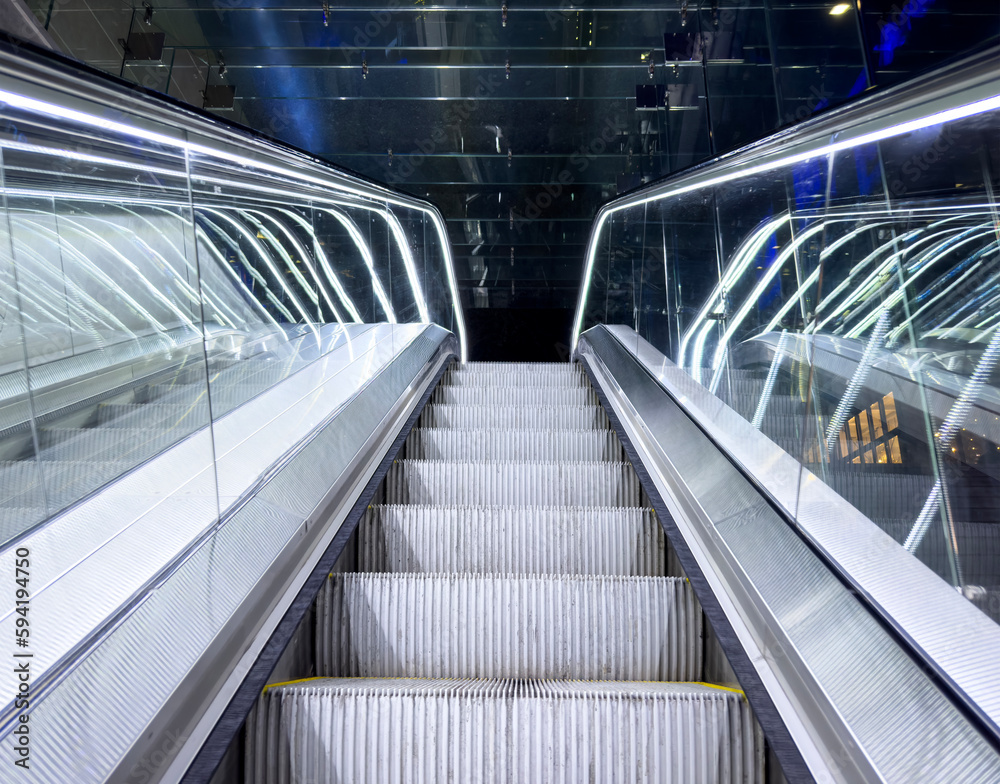Escalators. Electric stairs in a public area. Modern automatic ...