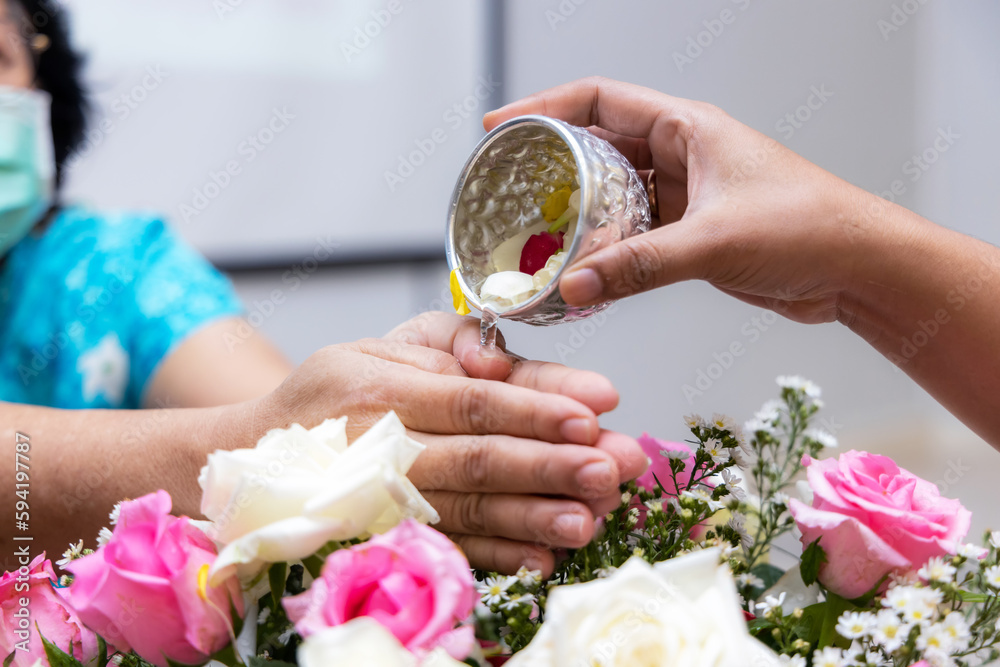 Pouring water on the hands of revered elders and ask for blessing in ...