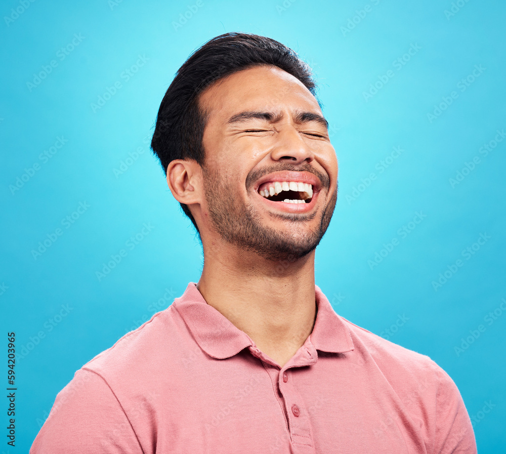 Laughing, funny comedy and man in studio isolated on a blue background ...