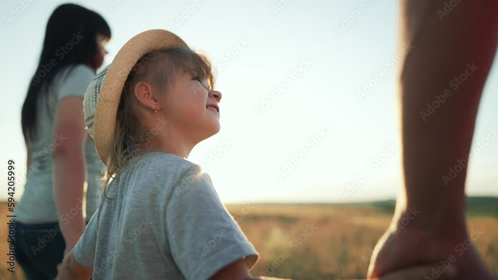 Vidéo Stock Happy family. Hand in hand parents and daughter. Girl is walking in the park with ...