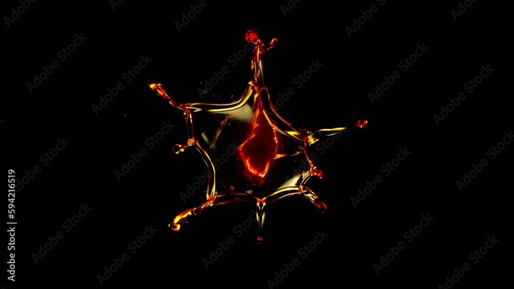 Super slow motion of splashing oil on black background. Filmed on high ...