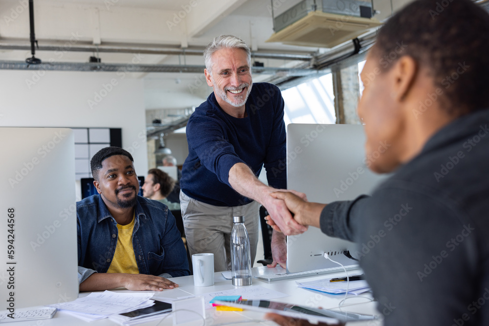 New employee being welcomed to the office with a handshake Stock Photo ...