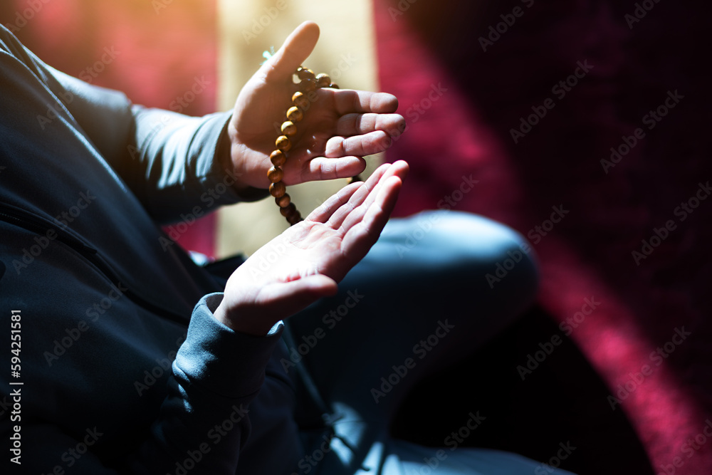 Hand of male muslim praying with mosque interior background during ...