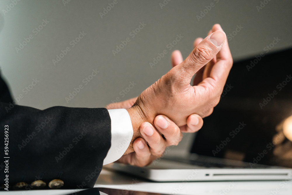 Businessman hand get hurt and pain in hand. Symptom office syndrome. He ...