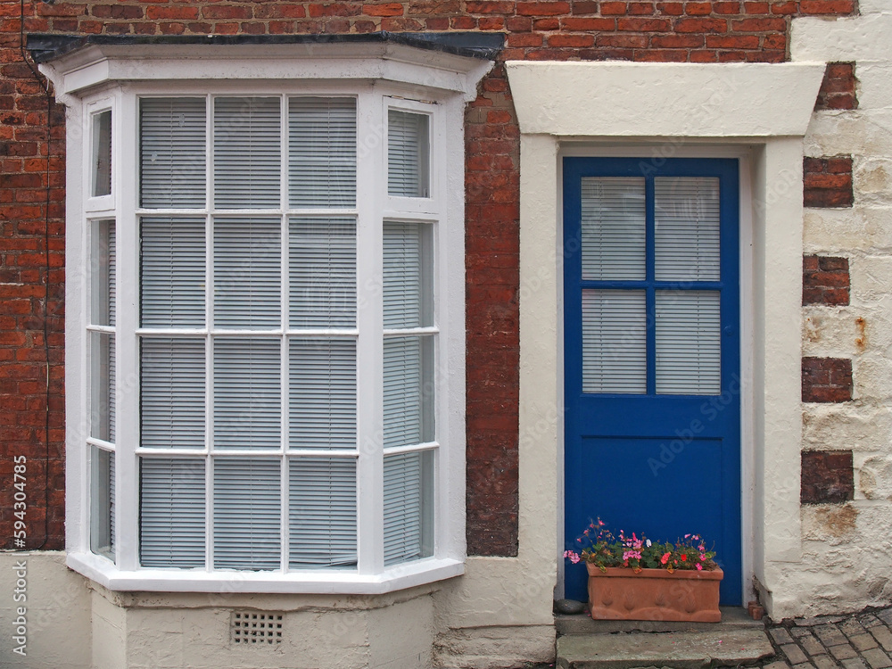 front view of a typical old small english terraced brick house with ...