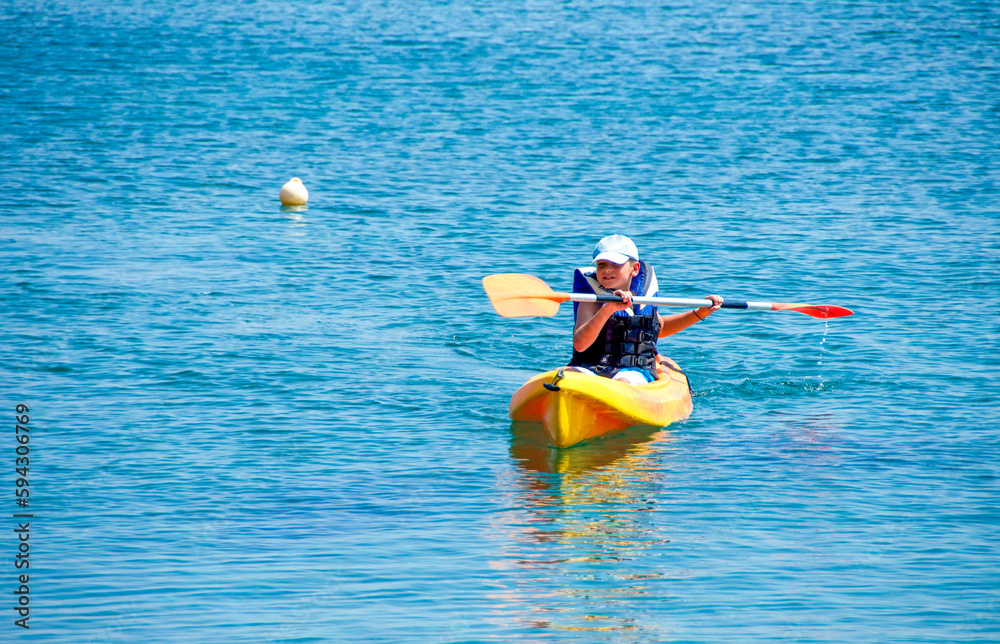 kayaking lessons. Boy with life buoy suit in kayak lessons during ...