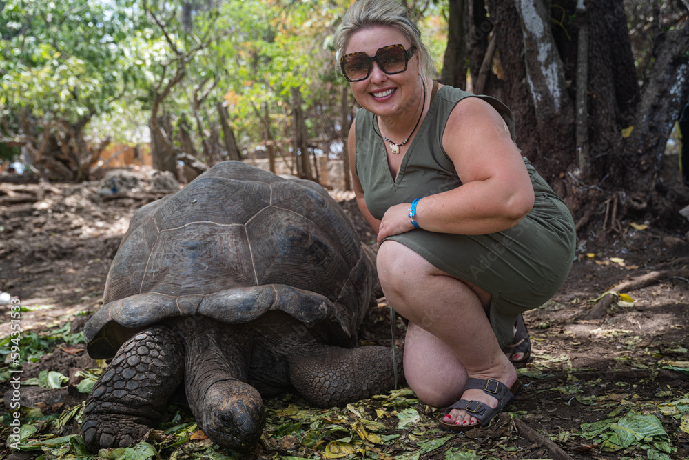 Woman poses with a giant turtle at the tortoise sanctuary on Prison ...