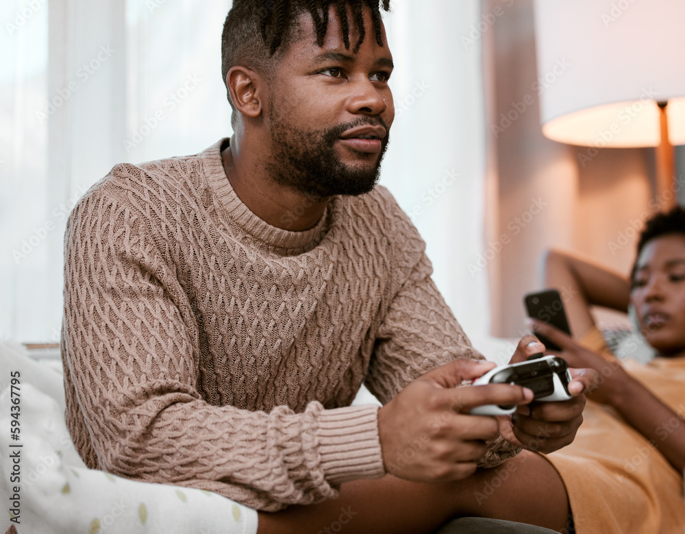Gaming allows you live more than one life. a handsome young man playing ...