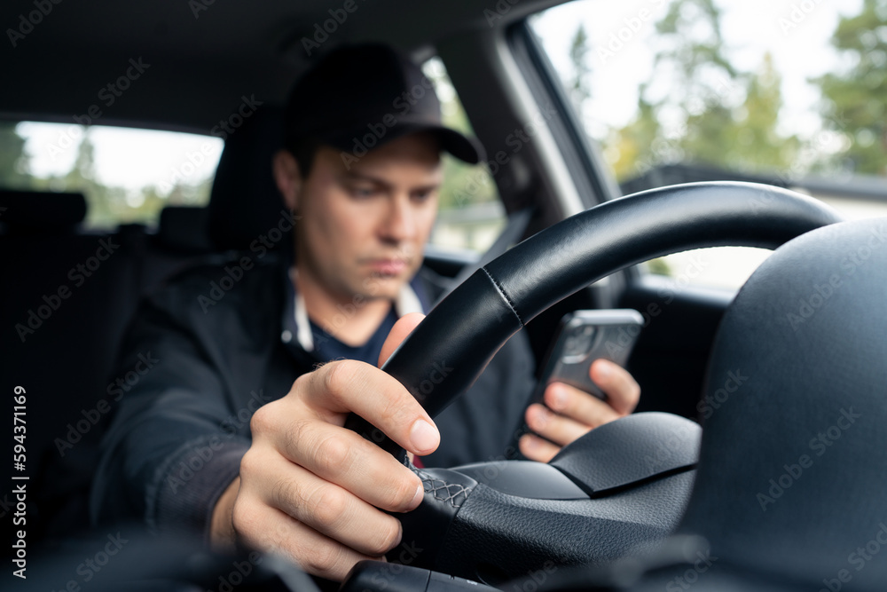 Foto de Driving car and using phone to text. Driver using cellphone ...