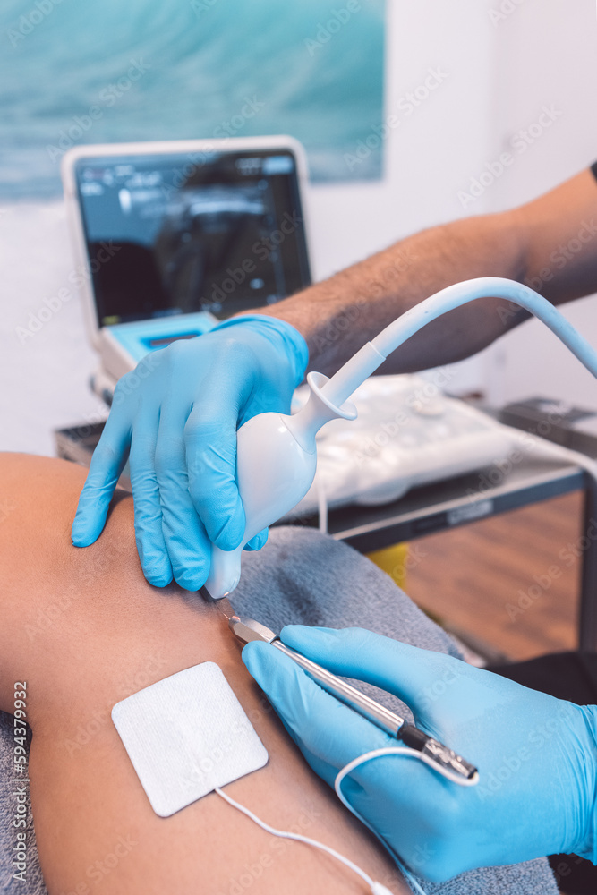Crop doctor treating patient with ultrasound Stock Photo | Adobe Stock