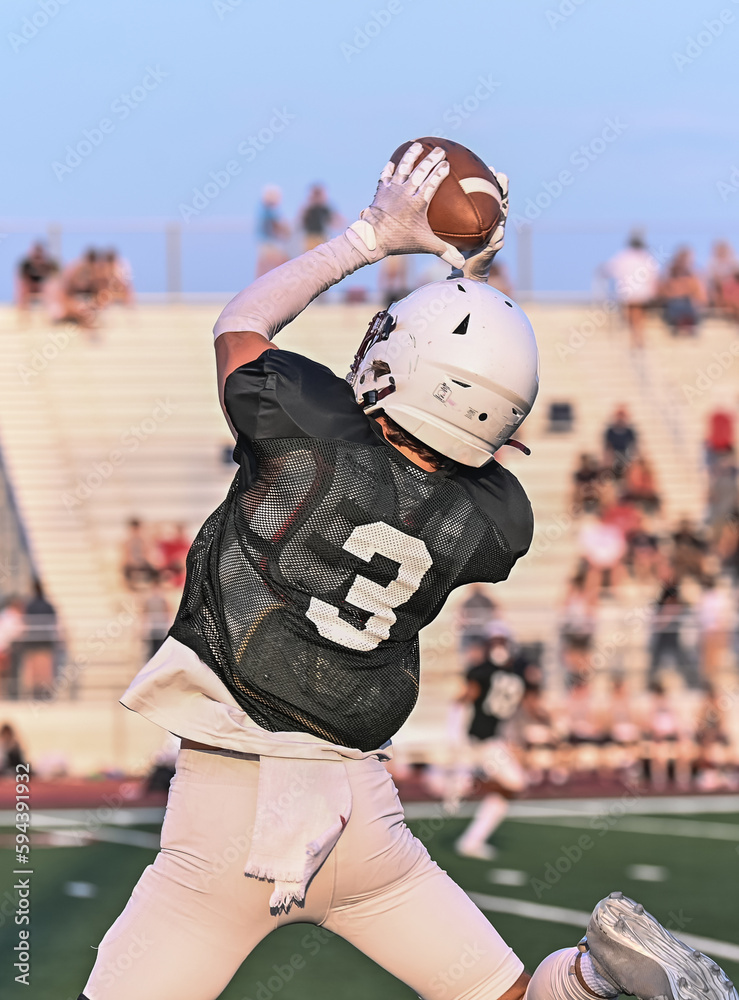 Young athletic young boys playing in a competitive game of tackle ...