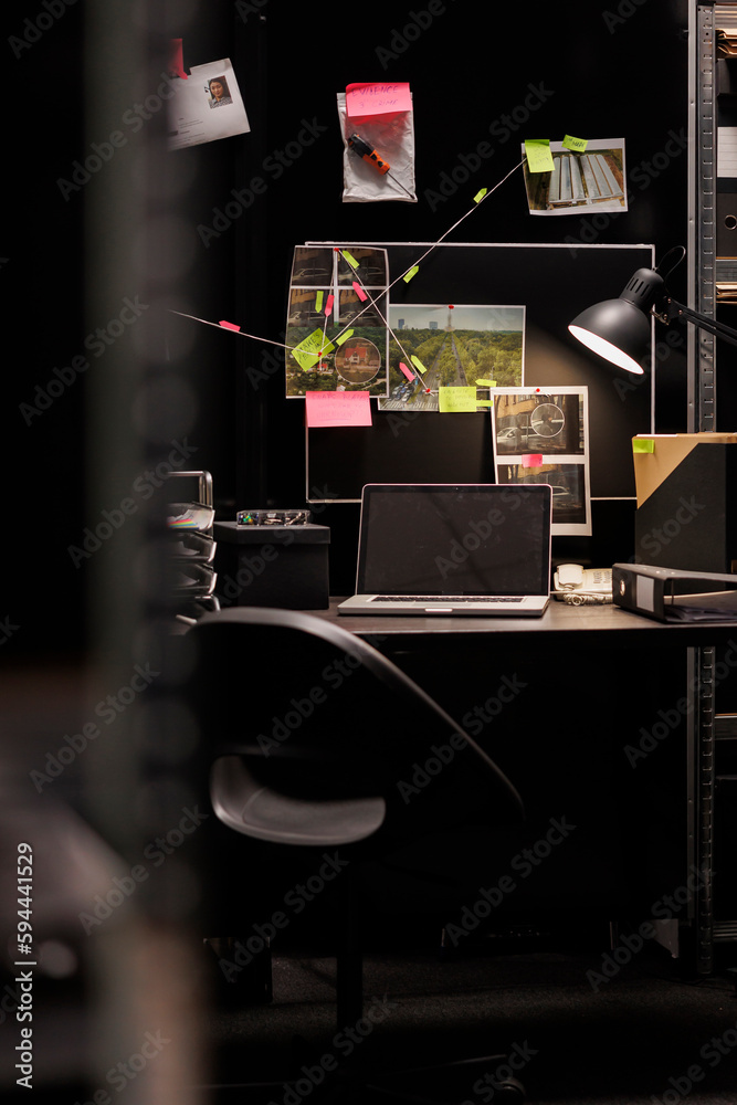 Detective board with clues hanging over desk in dark police inspector ...