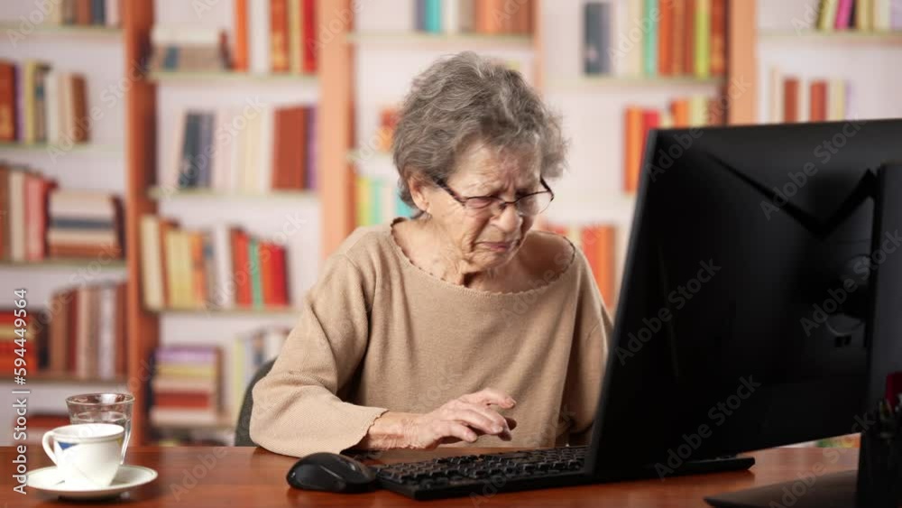 Angry stressed elderly old woman 80s, using computer gets bad news. Mad ...