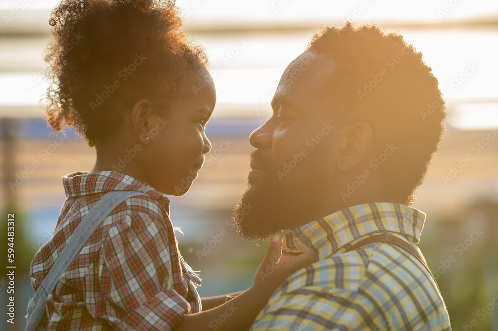 Happy african black parents dad father with daughter child on piggyback ...