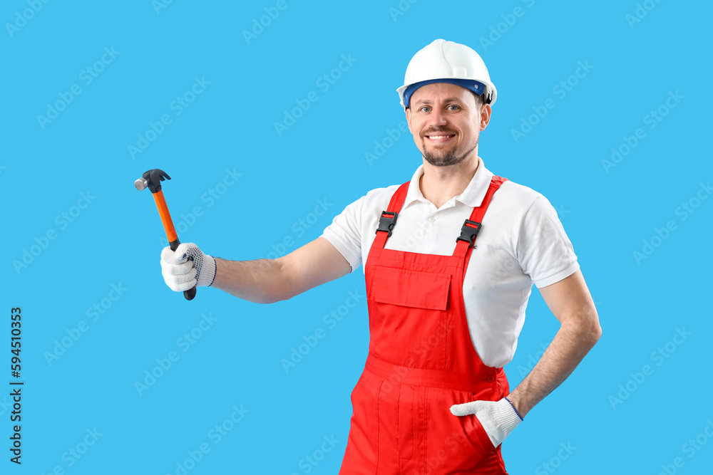 Male carpenter with hammer on blue background Stock Photo | Adobe Stock