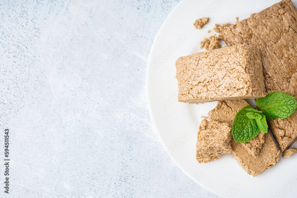 Plate with pieces of tasty halva on light background Stock Photo ...