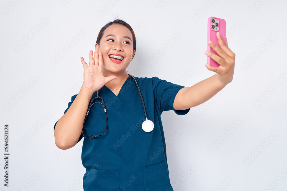 Smiling friendly young Asian woman nurse working wearing blue uniform ...