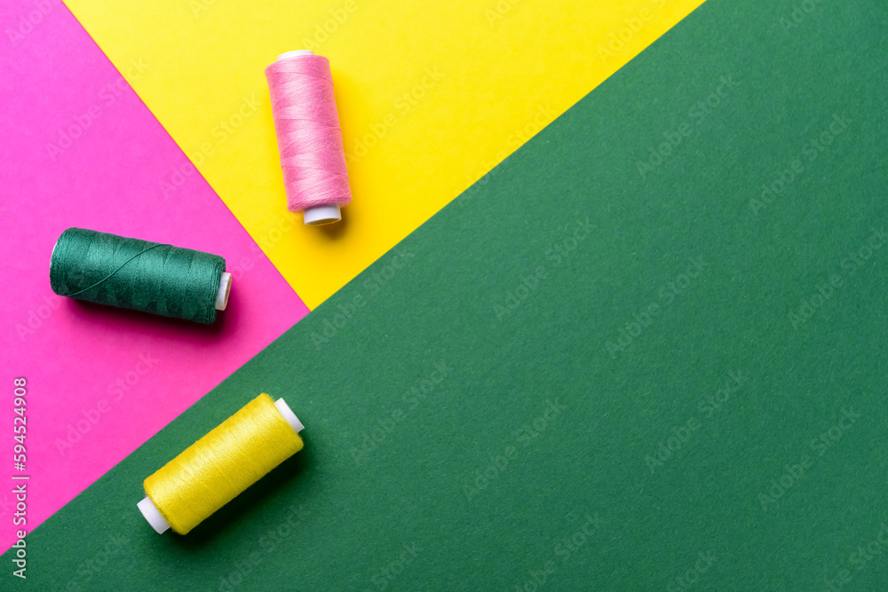 Set of thread spools on color background Stock Photo | Adobe Stock