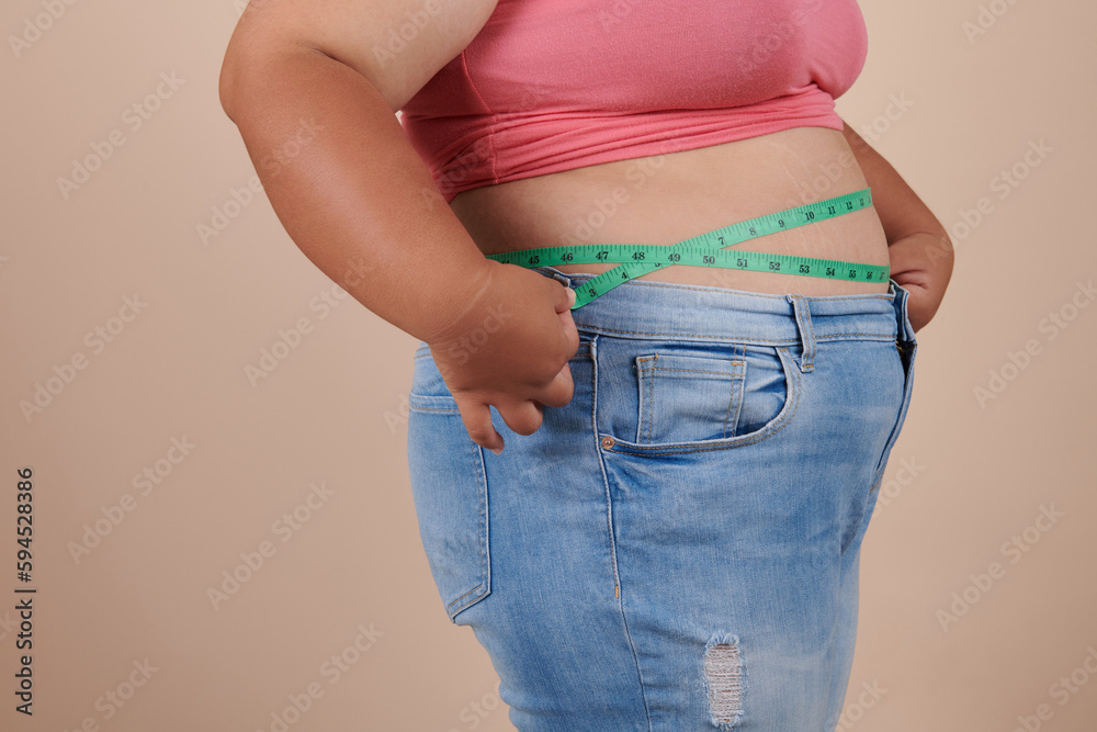 fat woman measuring her stomach, isolate on white background, she wants ...