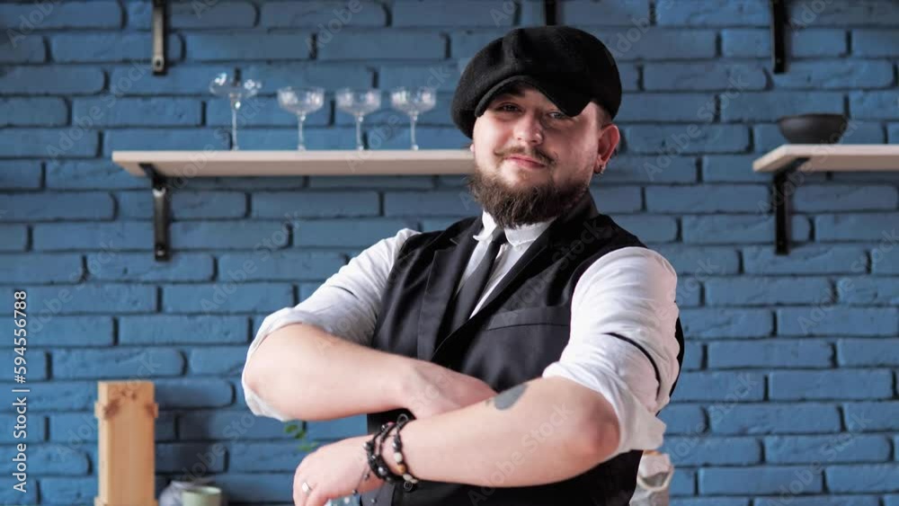 Stockvideo Handsome, authentic, cheerful, smiling bartender folds hands ...