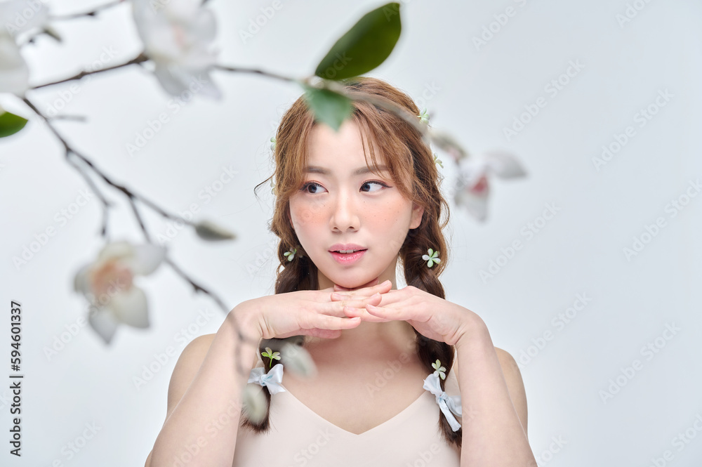 Beautiful Young Asian woman behind flower in beauty pose. Pretty girl ...