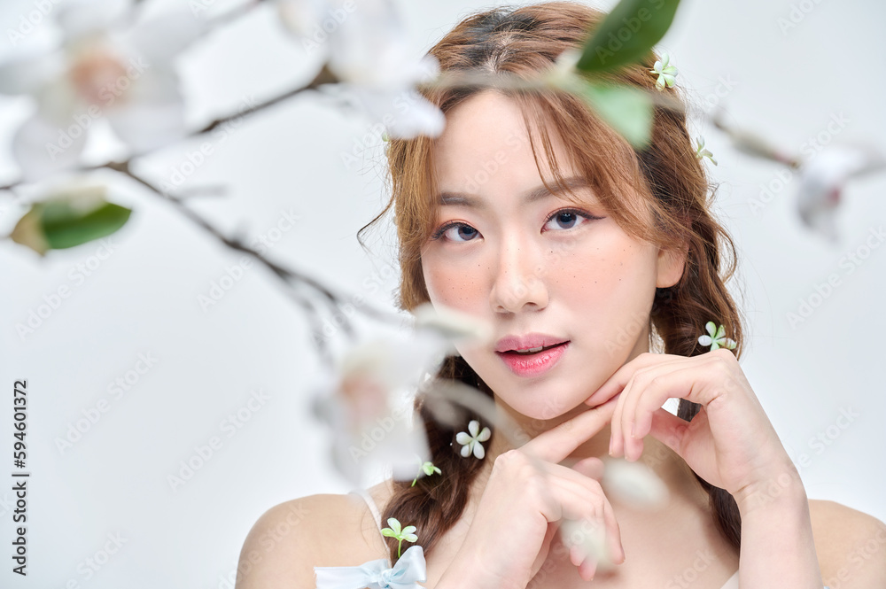 Beautiful Young Asian woman behind flower in beauty pose. Pretty girl ...