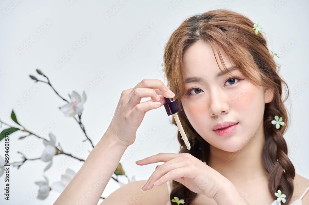 Beautiful Young Asian woman behind flower in beauty pose. Pretty girl ...