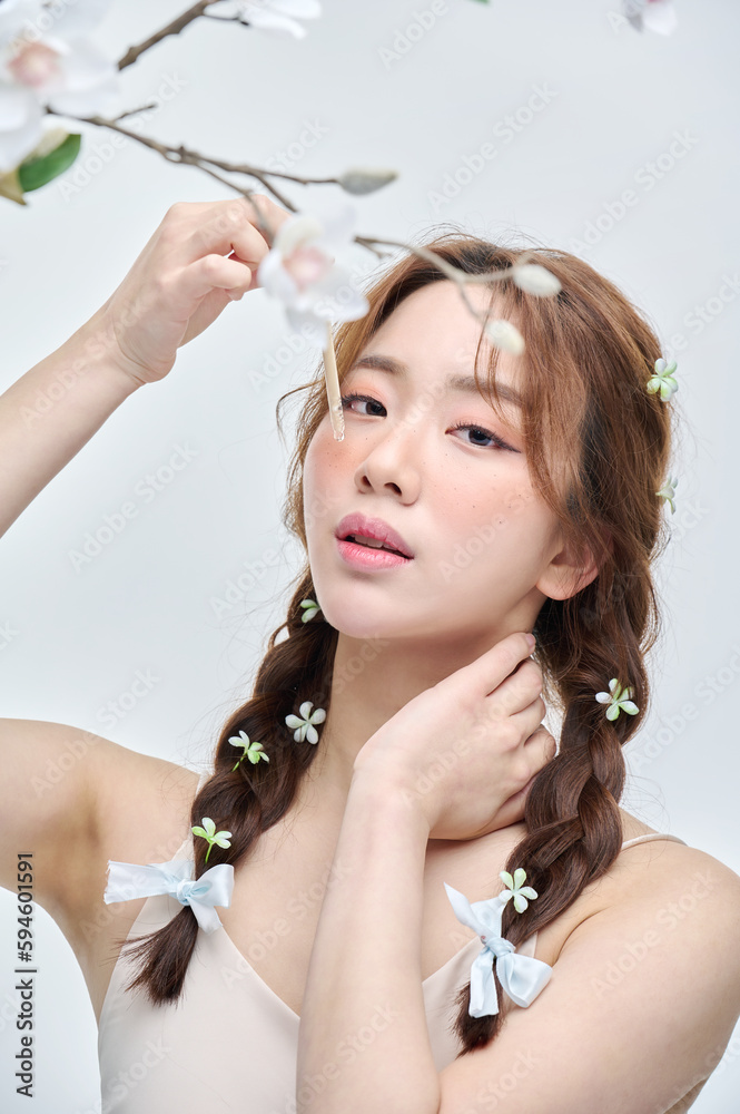Beautiful Young Asian woman behind flower in beauty pose. Pretty girl ...