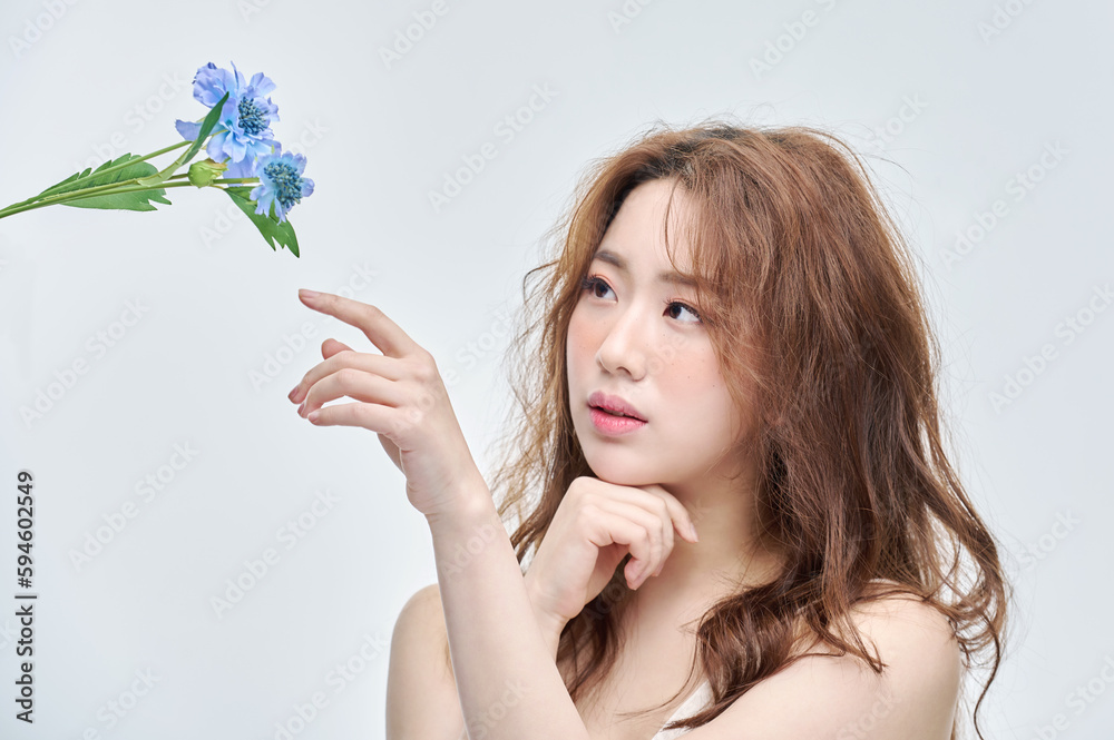 Beautiful Young Asian woman behind flower in beauty pose. Pretty girl ...