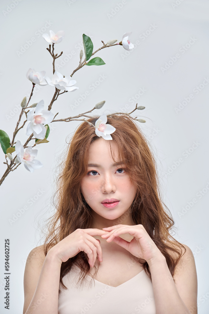 Beautiful Young Asian woman behind flower in beauty pose. Pretty girl ...