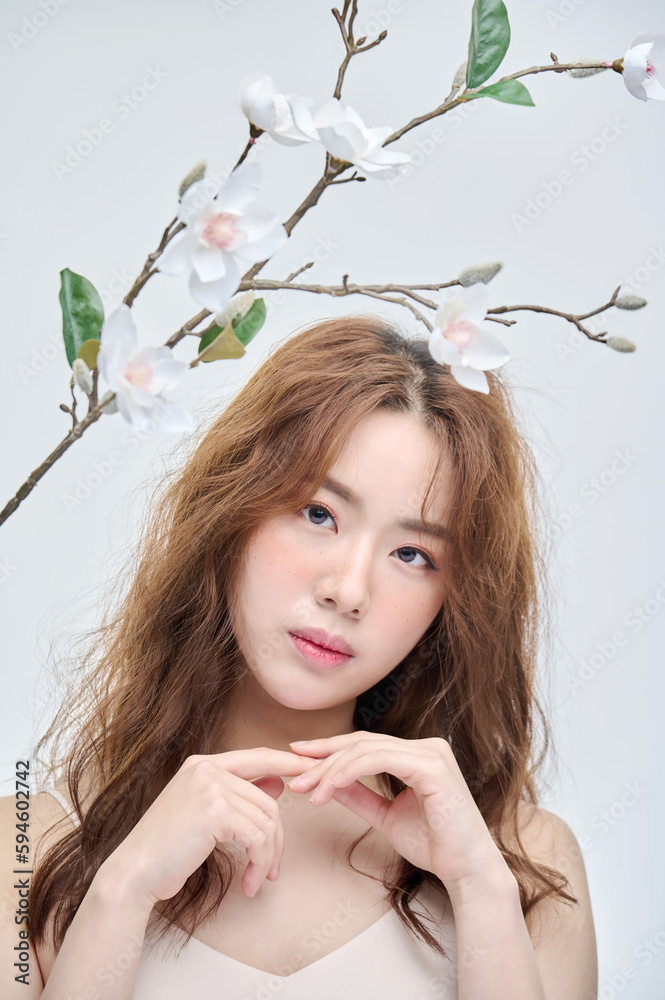 Beautiful Young Asian woman behind flower in beauty pose. Pretty girl ...