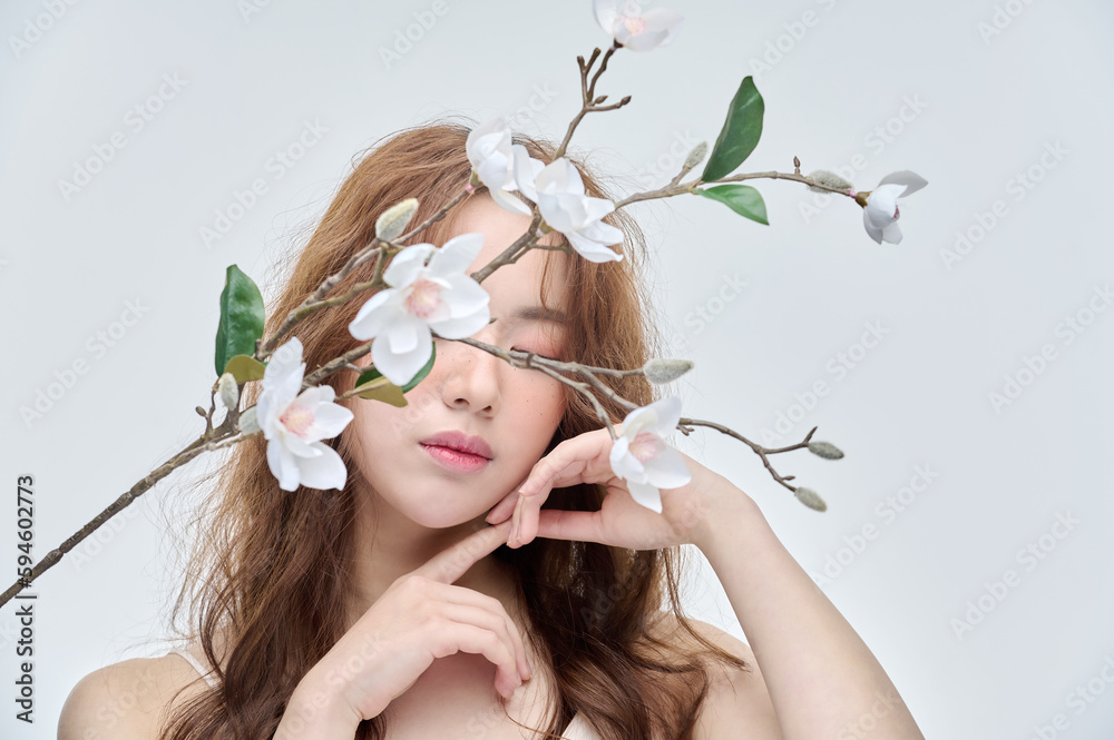 Beautiful Young Asian woman behind flower in beauty pose. Pretty girl ...