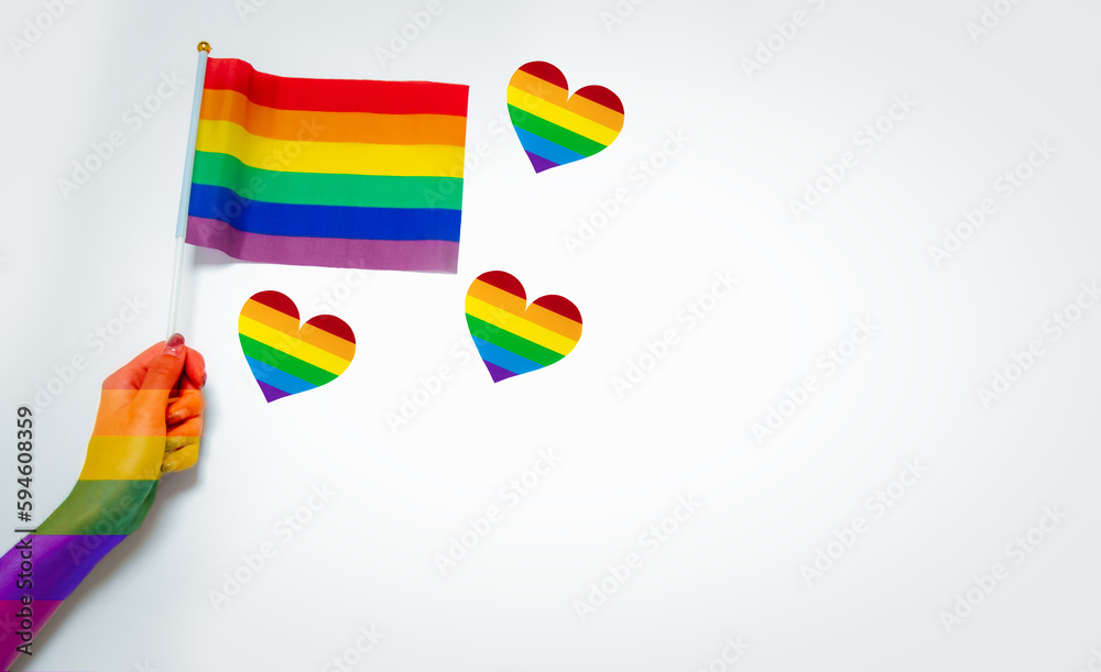 gay pride month and lgbtq festival concept. a hand holding pride flags ...