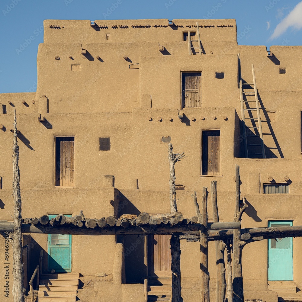 Large adobe structure with exterior stairs leading up to the roof Stock ...