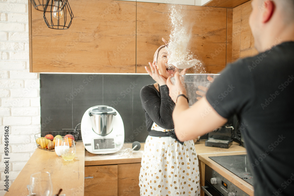 Portrait of family standing in kitchen at home. Young woman with open ...